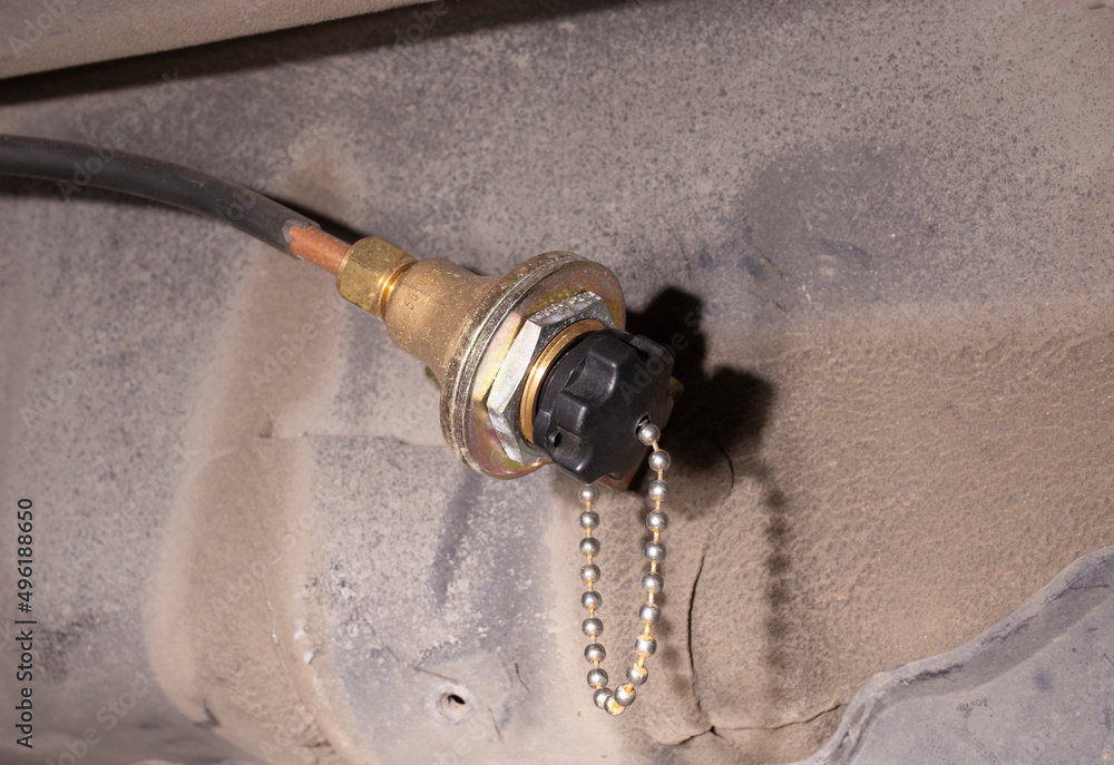 Gas refill pipe of LPG gas tank with a cover under in the automobile ...