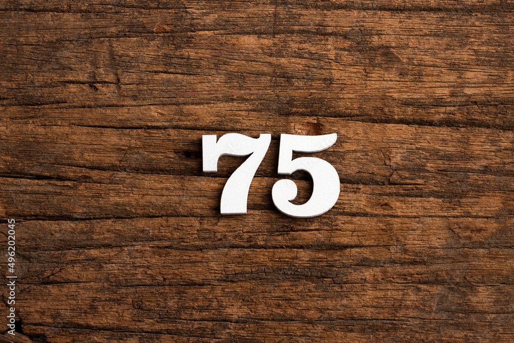 Number 75 in wood, isolated on rustic background Stock Photo | Adobe Stock