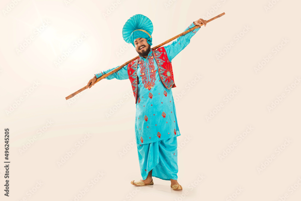 Sikh Man doing bhangra with khunda during Baisakhi celebration Stock ...