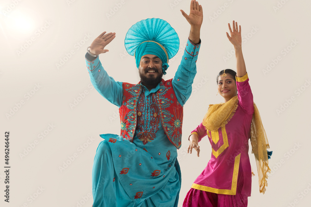 Sikh couple performing bhangra together during Baisakhi celebration ...