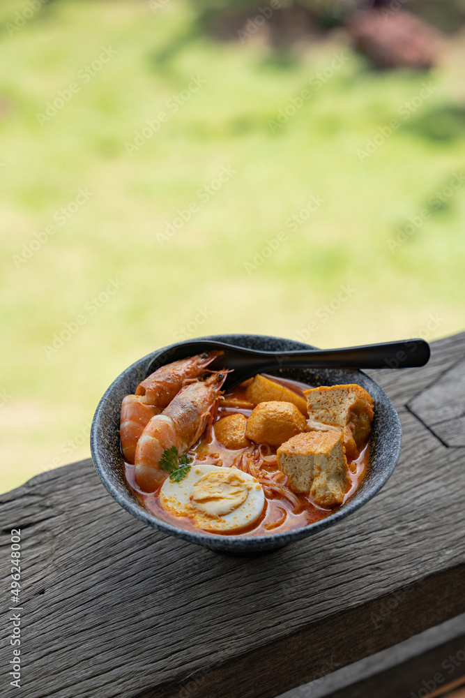 authentic Singaporean laksa; a spicy curry coconut soup consist of ...