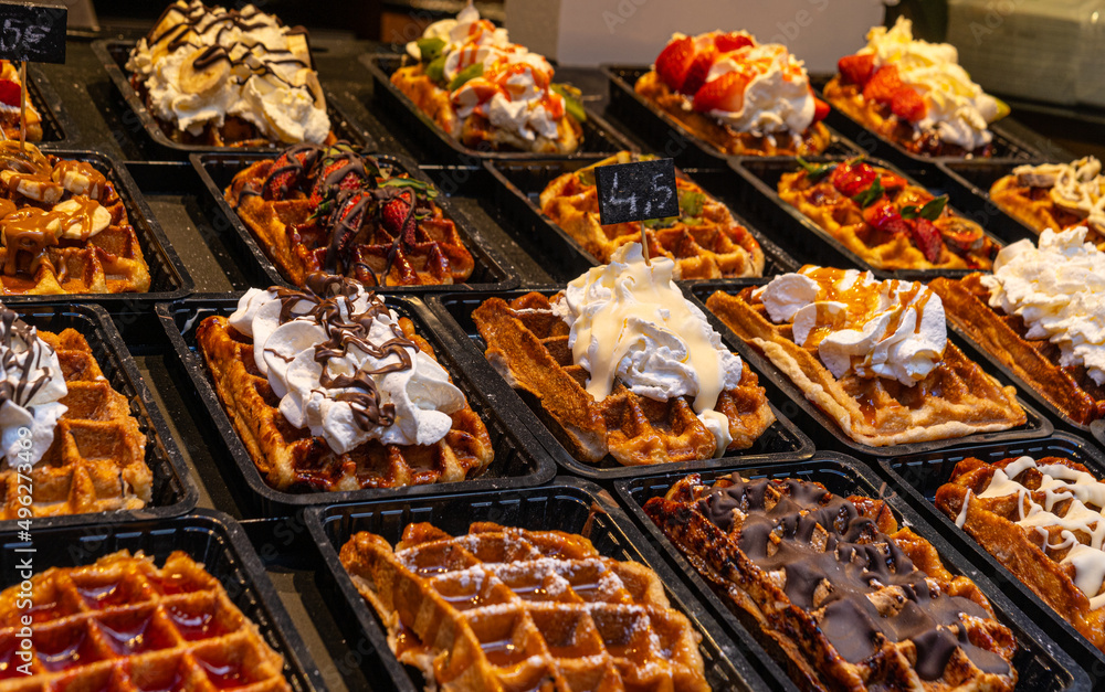 Delicious traditional Liege waffles with colorful toppings on display ...