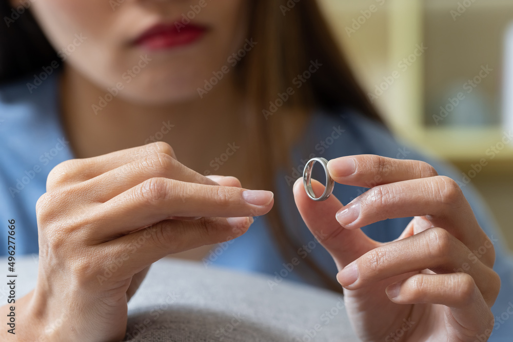 woman taking off wedding ring Stock Photo | Adobe Stock