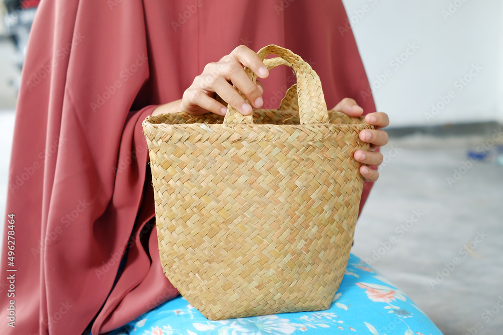 Woman holding a basket made of pandan leaves. Rural women use pandan ...