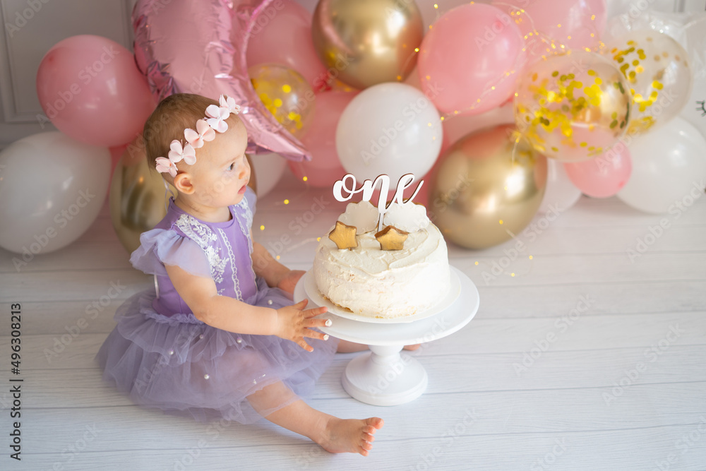 Cute little baby girl sitting on the floor and playing with his cake on ...