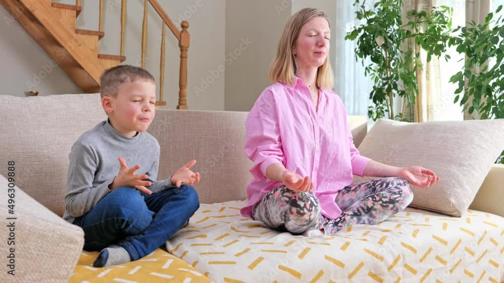 Mother or nanny with baby child make yoga at home on bed to be strong ...