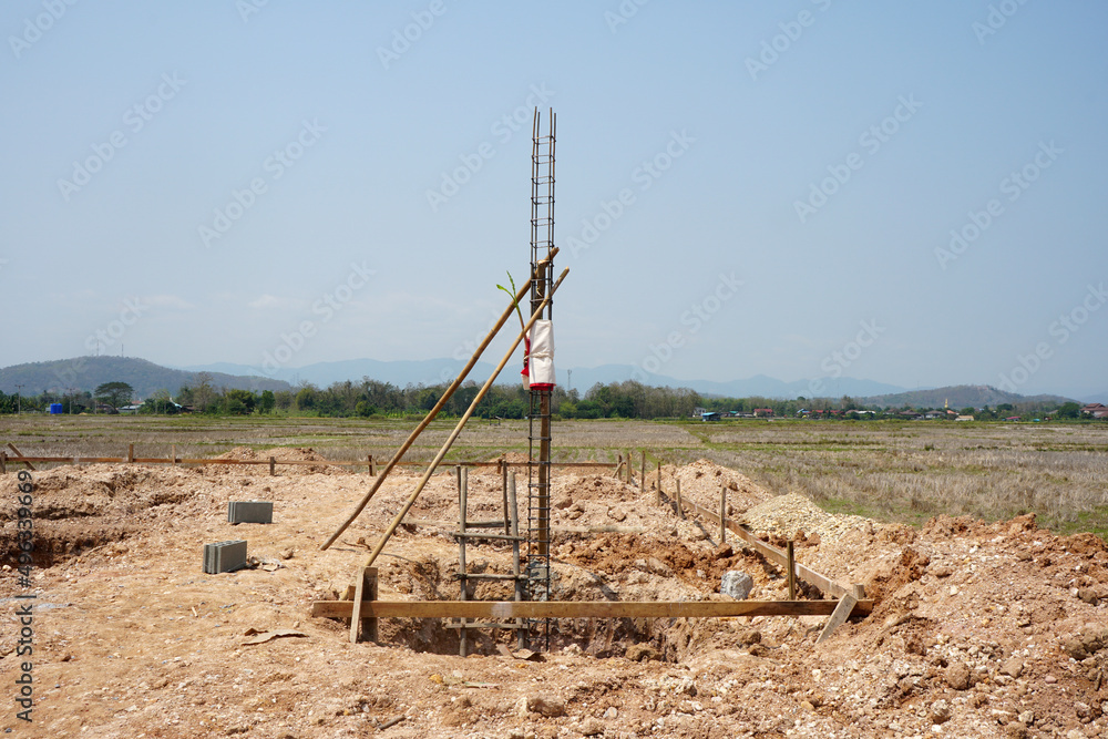 setting up the main pillar on the construction site. Steel reinforced ...