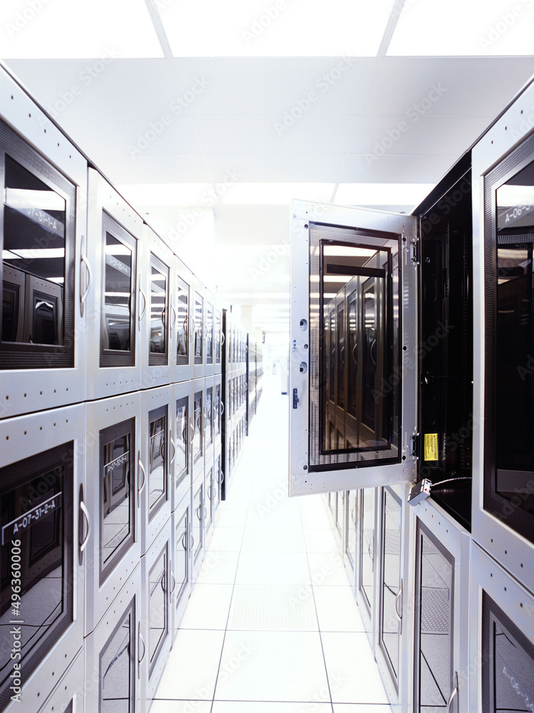 Large empty server room with one cabinet open in foreground Stock Photo ...