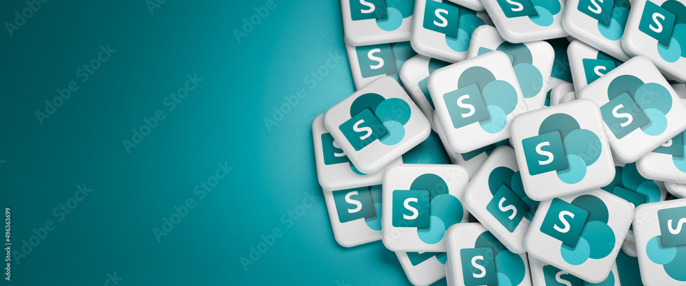 Logos of the Microsoft collaboration platform Sharepoint on a heap on a table. Web banner format ...