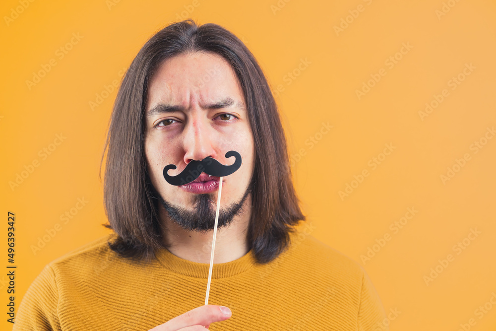 Studio portrait of caucasian bearded man in disguise created by fake ...