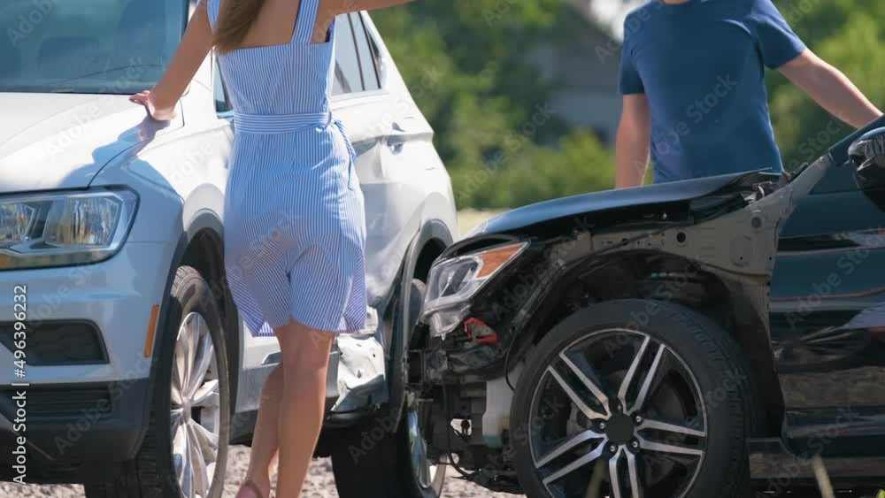 Angry woman and man drivers of heavily damaged vehicles arguing who is ...