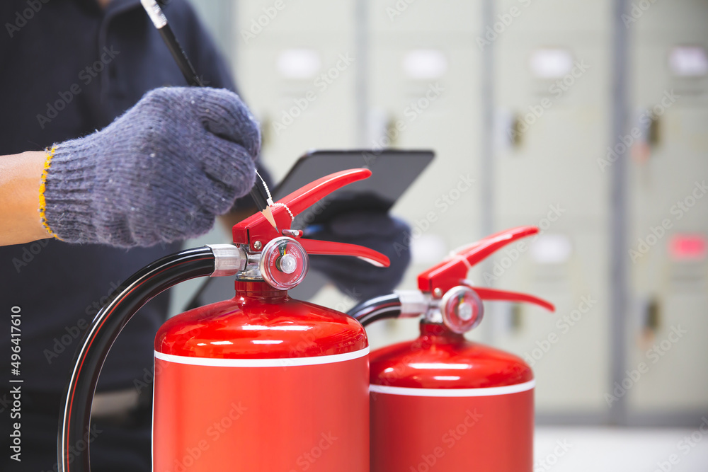 Fire extinguisher has hand engineer inspection checking pressure gauges ...