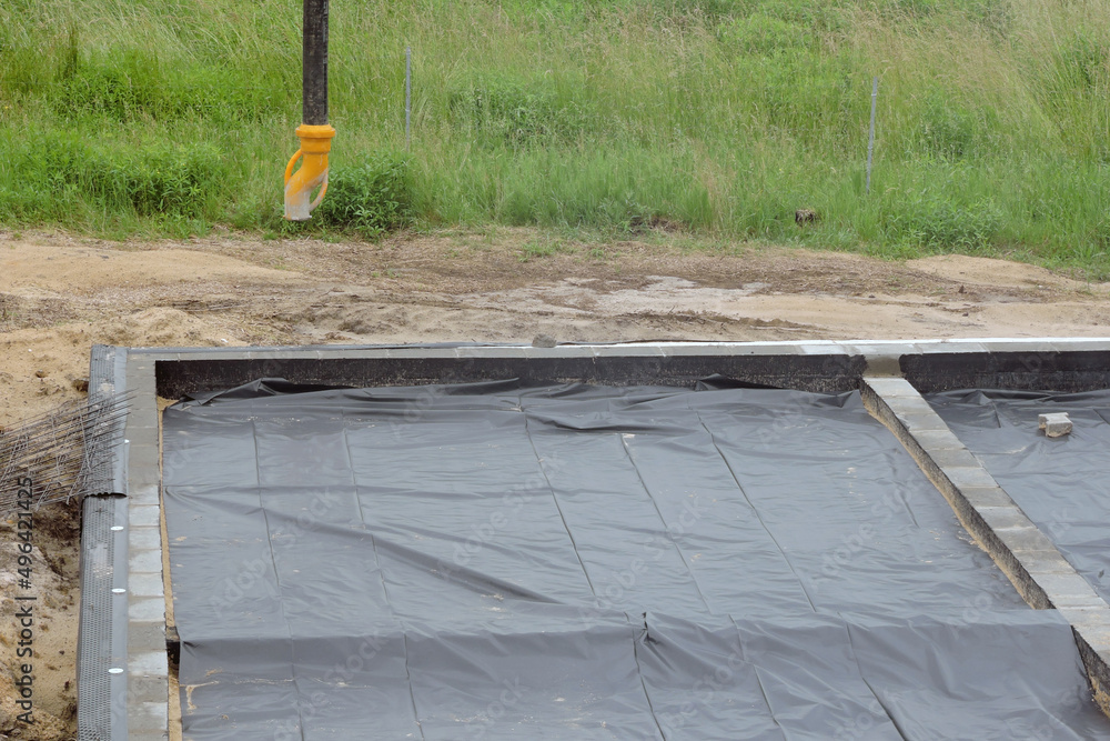A pipe of a concrete truck ready to pour concrete slab, damp proof ...