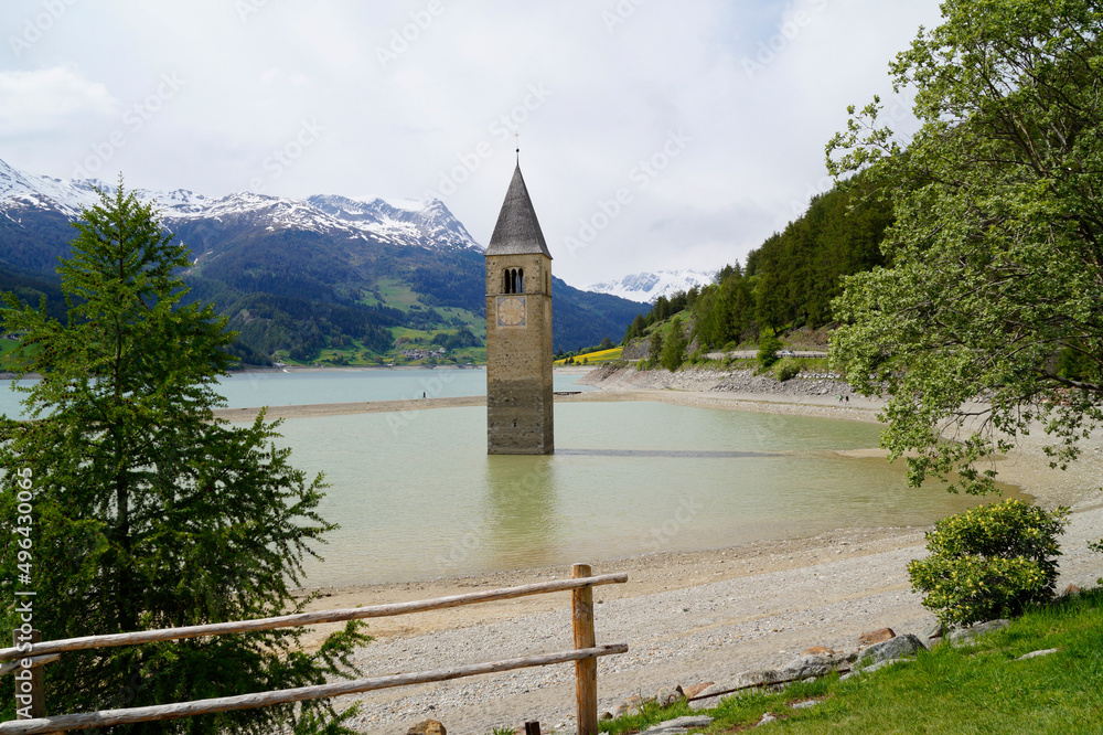 a picturesque view of lake Resia and the sunken church steeple of Lago ...