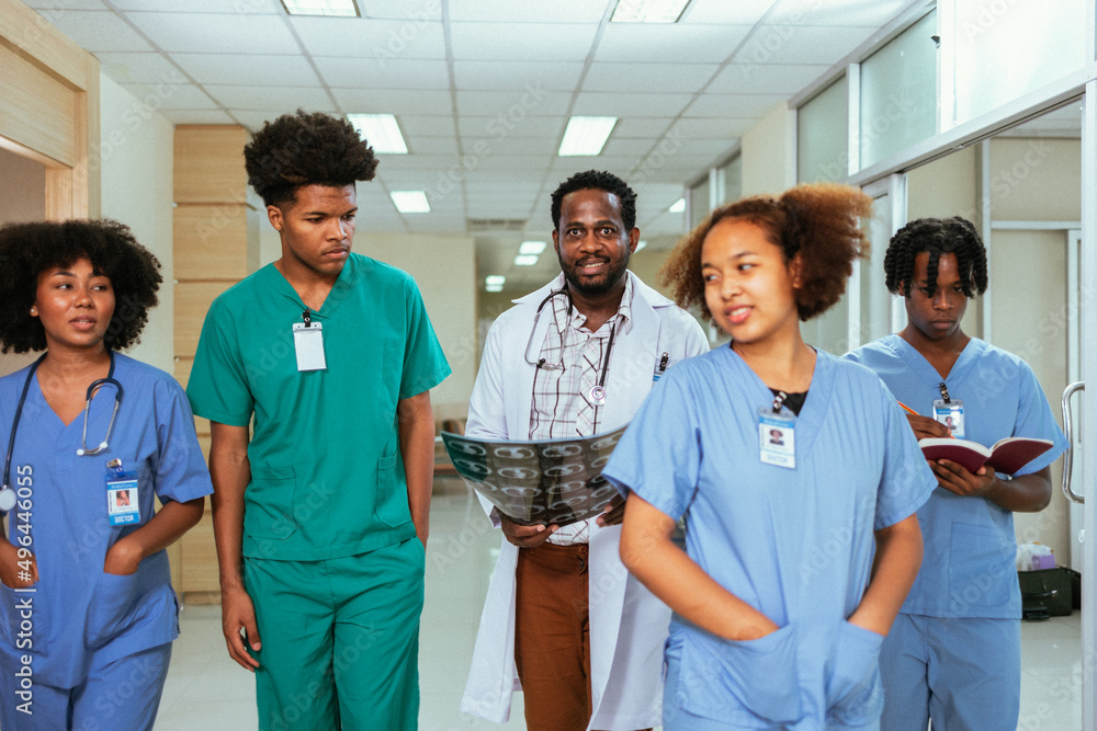 Group of medical students walking in a hallway at medical university ...