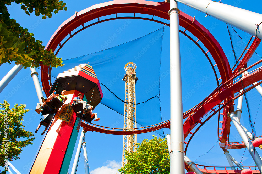 COPENHAGEN, DENMARK - JUNE 30, 2014: Demon Roller Coaster, Golden Tower ...