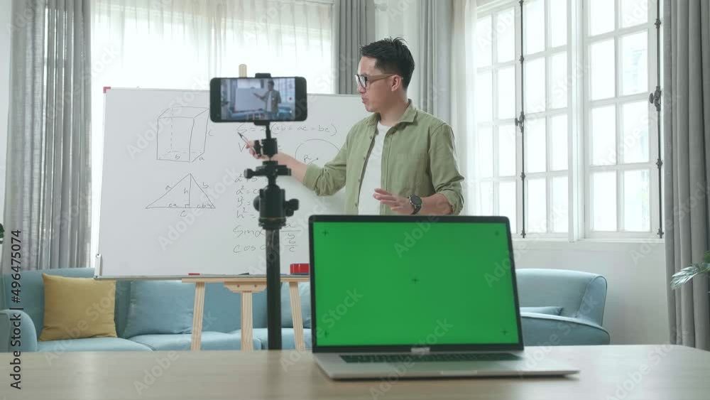 Asian Male Teacher With Glasses And Green Screen Laptop Shoots Video By ...