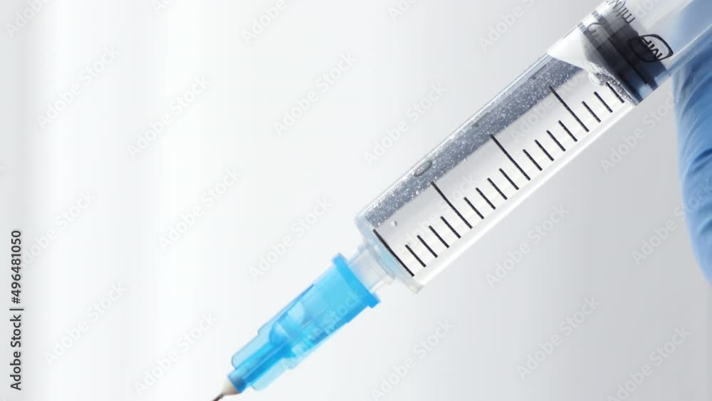 Close Up of injection liquid being in syringe. Medication drug needle ...