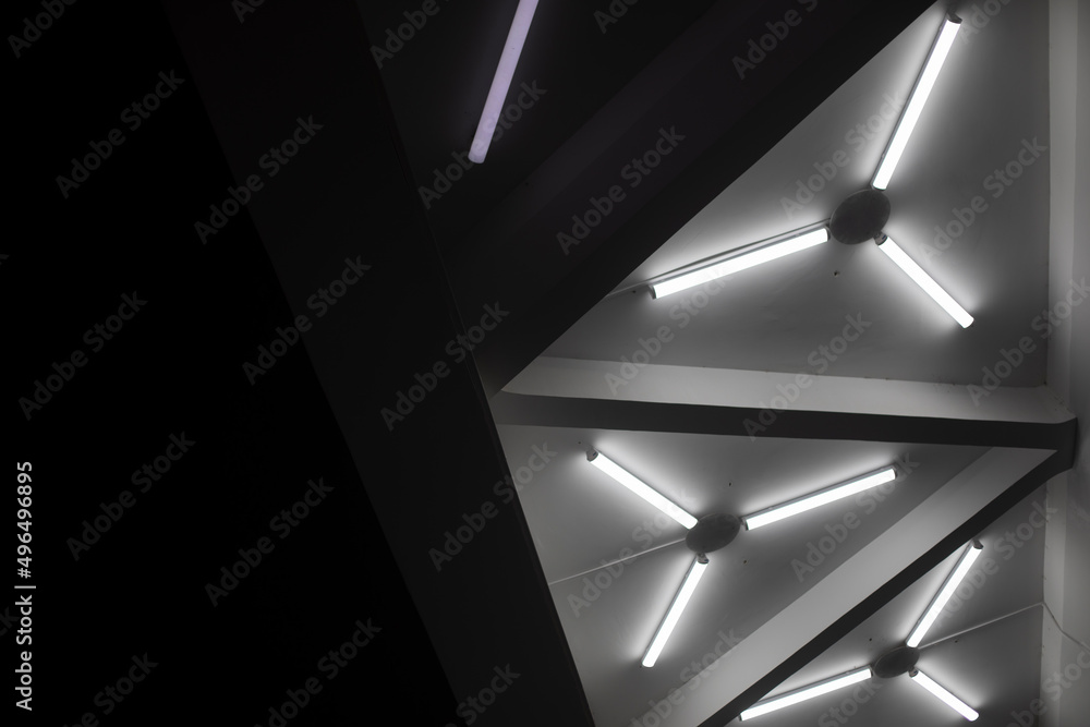 Light design. Fluorescent lamps on ceiling. Triangles of lamps ...