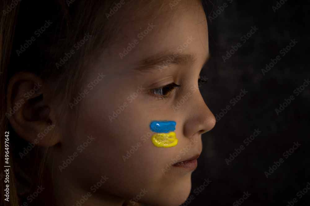 A child with the flag of Ukraine is crying. Sadness longing hope. Tear ...