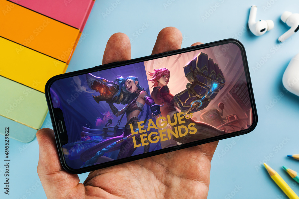 Man holding a smartphone with League of Legends (LOL) mobile game app ...