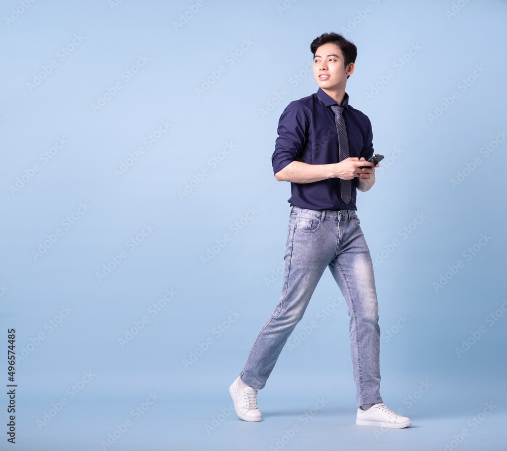 Full length image of young Asian businessman on blue background Stock ...