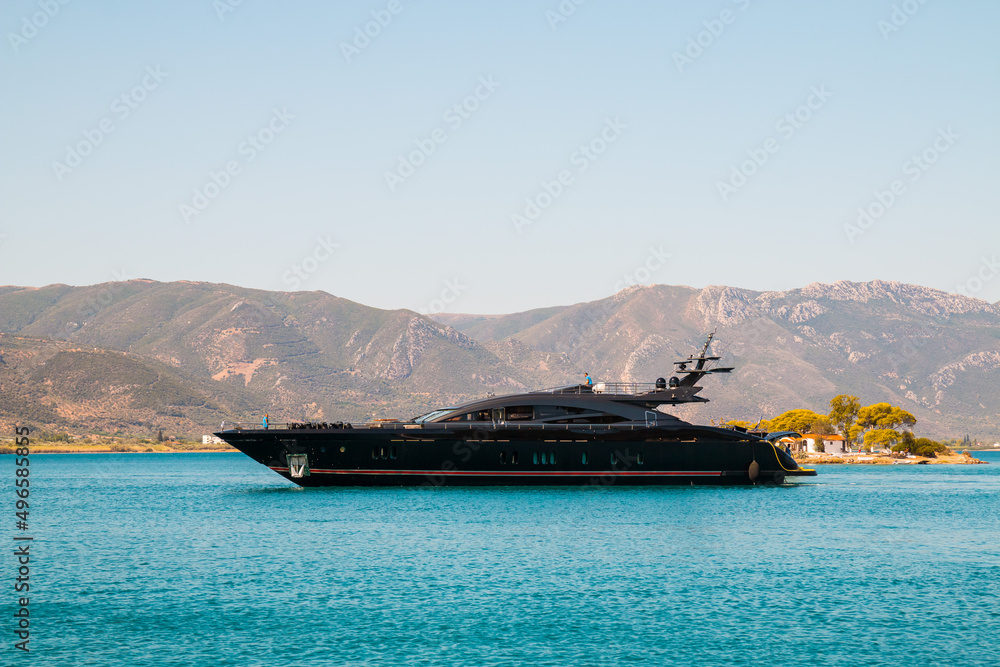 View on big black yacht staying on anchor in the Russian bay, half ...