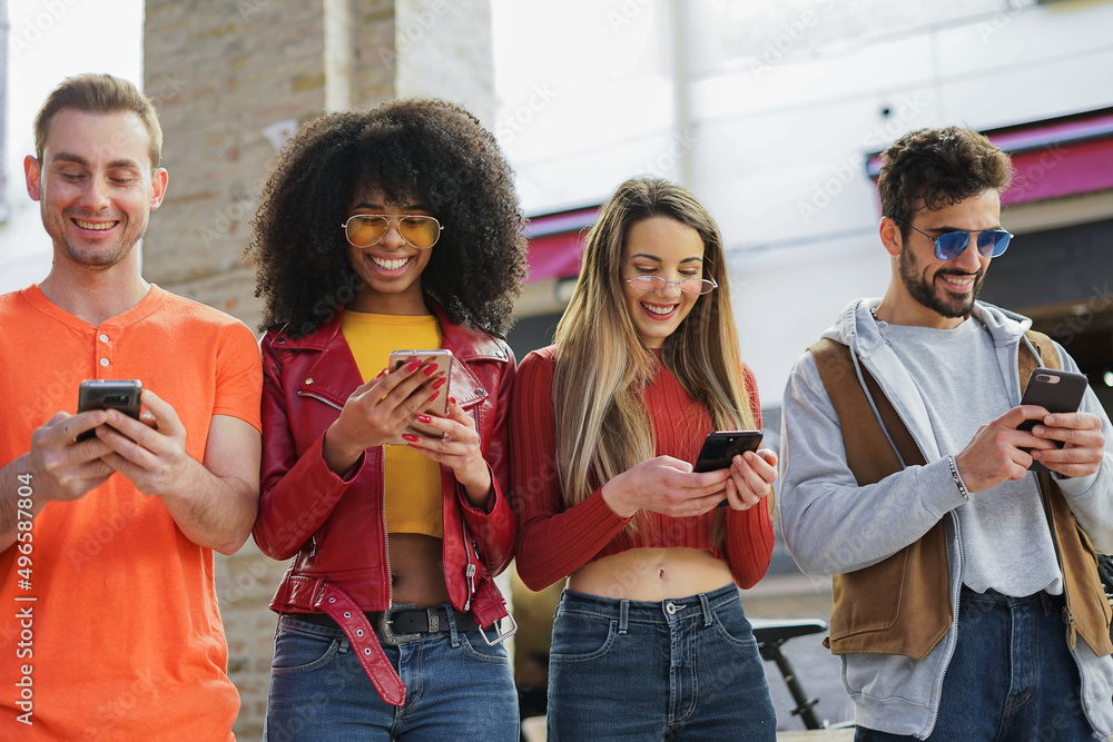 Group of influencer holding smartphone in hands and sharing photos and ...