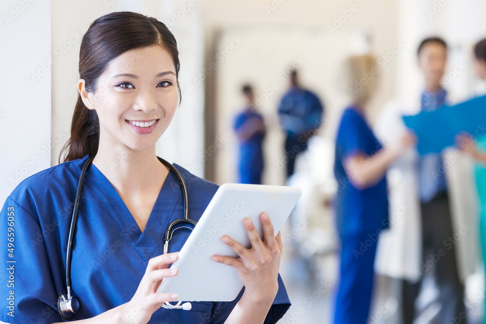 Portrait Asian Chinese female hospital nurse in scrubs with touch ...