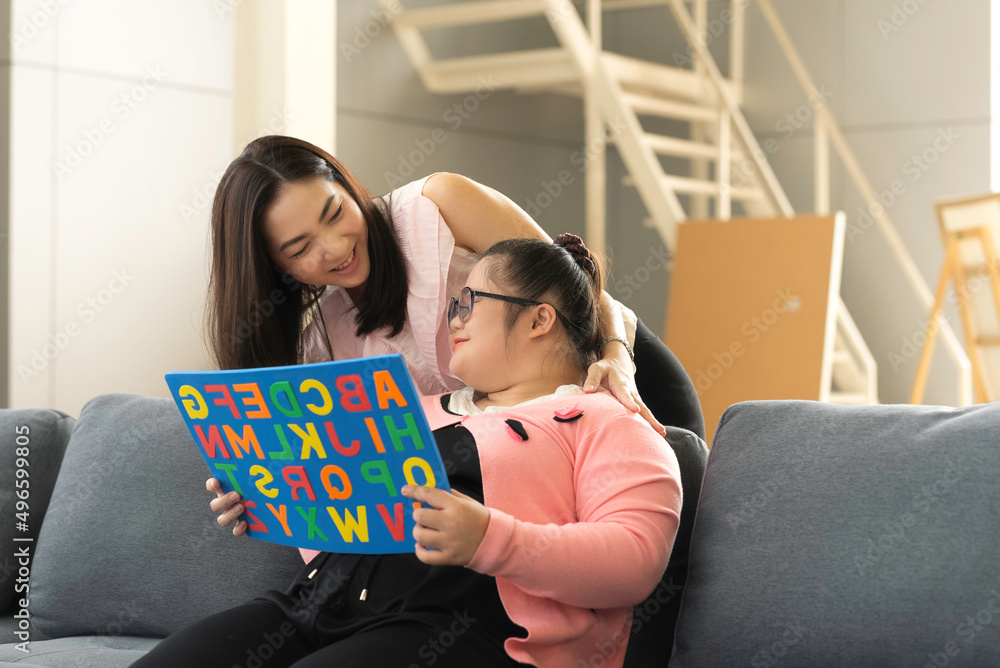 young girl with autism is practicing fun playing with toys at home with ...