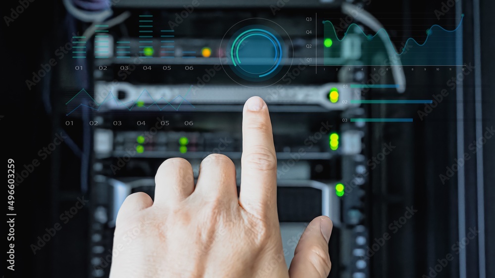 hand of man operating monitor network system via digital control panel ...