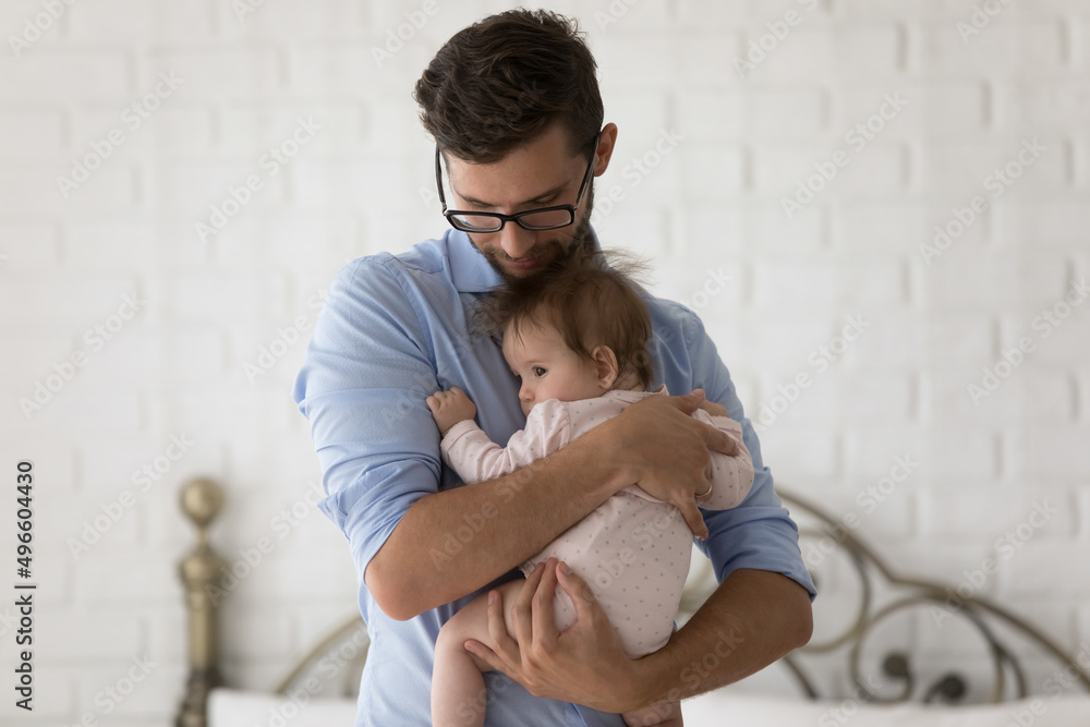 Caring dad holding rocking, calming adorable baby, holding little ...