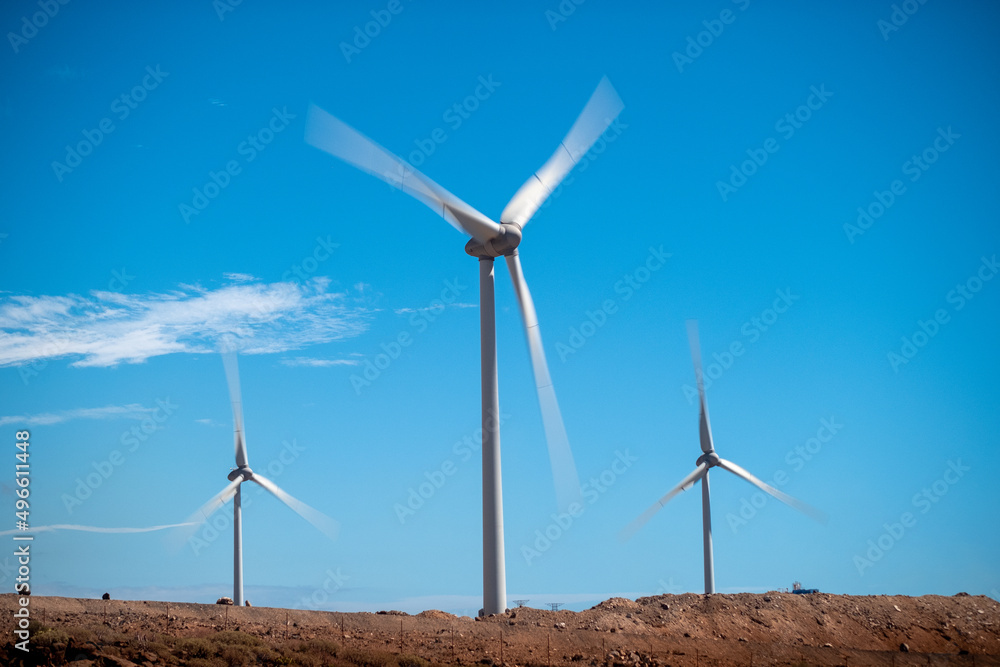 windmills operating on a windy day, with blades in movement Stock Photo ...