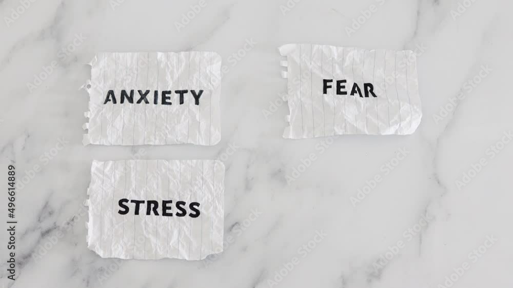 hand pushing Stress Fear Anxiety and Burnout texts away and placing ...