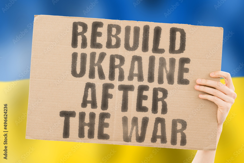 The phrase " Rebuild Ukraine after the war " is on a banner in men's ...