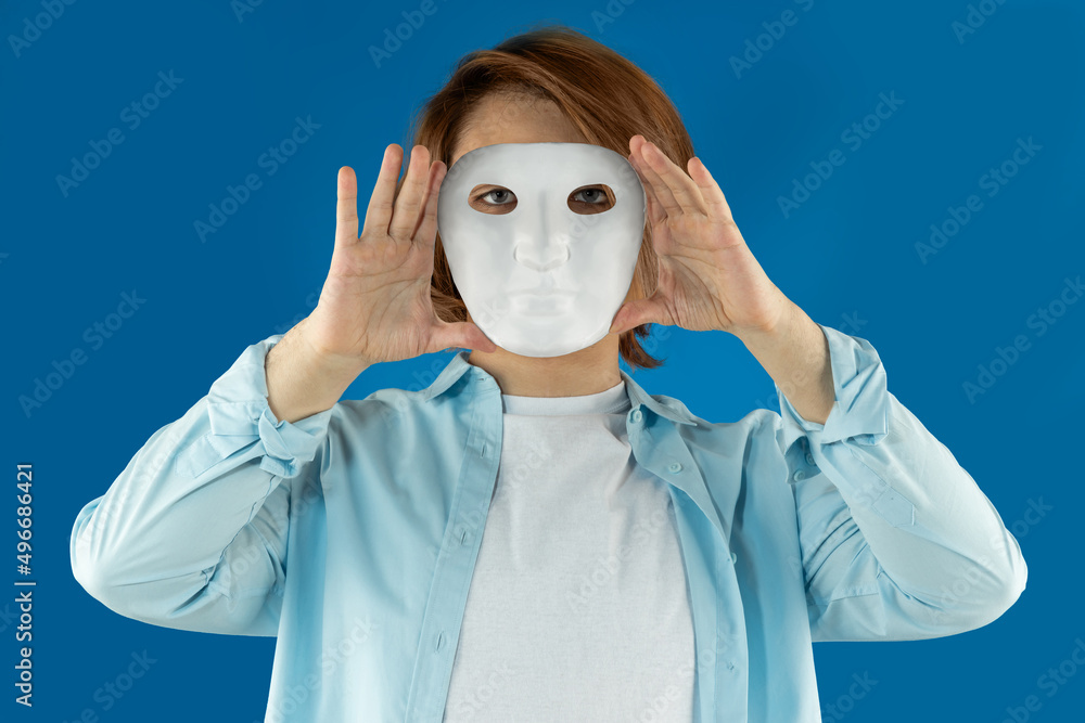 Mental health concept. Young man holding a full-face mask, ball, or ...