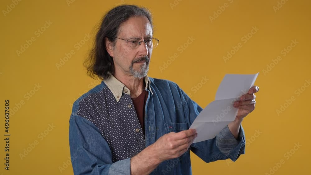 Portrait of angry stressed businessman opening letter reading bad news ...