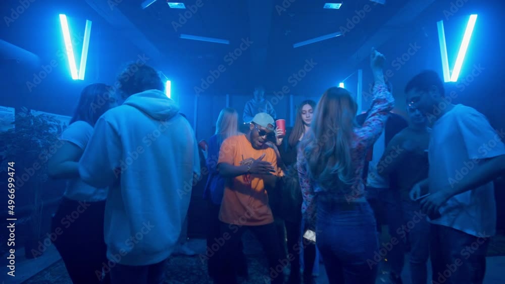 An African-American man dances in a crowd in a nightclub on the dance ...