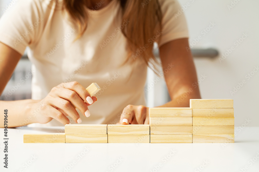 Women hand put wooden blocks in the shape of a staircase Stock Photo ...