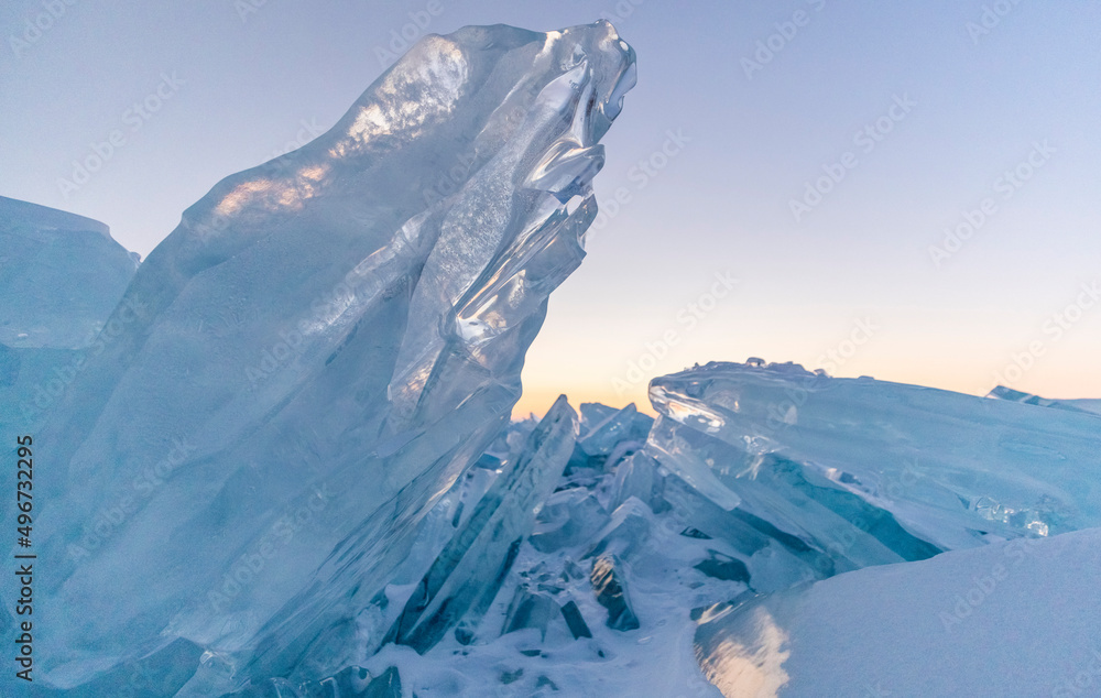 Beautiful transparent blue ice blocks on frozen lake Baikal, sunset sky ...