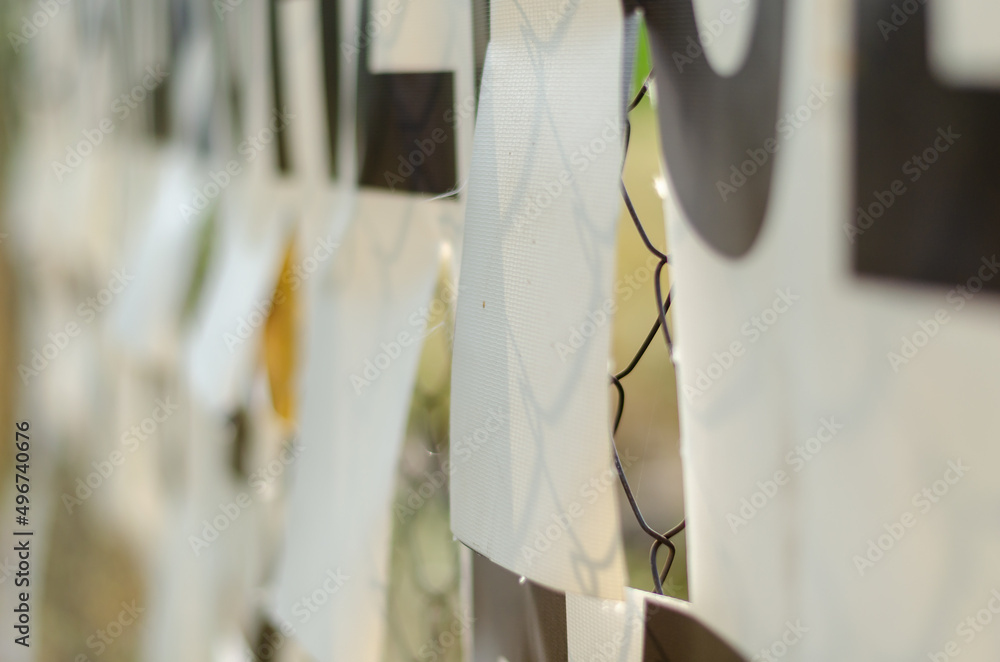 The banner is attached to the Rabitz grid. White banner with perforated ...