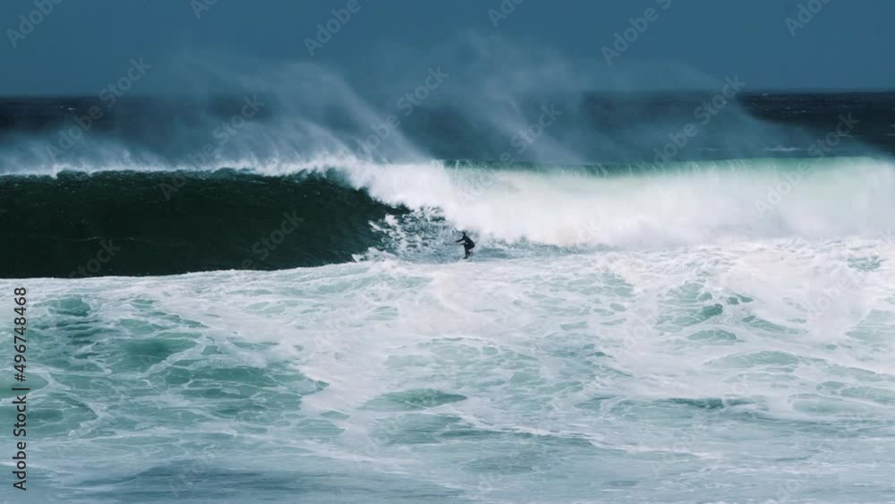 Big wave surfer riding a big wave Stock Video | Adobe Stock