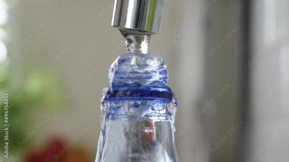 Filling a Plastic Bottle with Fresh Water. Making Water Reserve in a ...