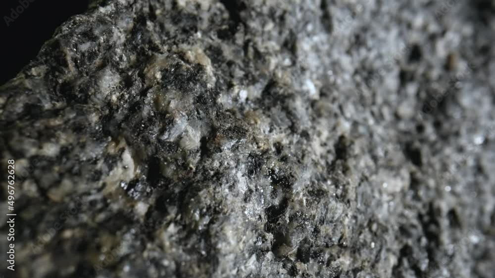 Background of natural stone texture of gray rough granite. A piece of stone with textured ...