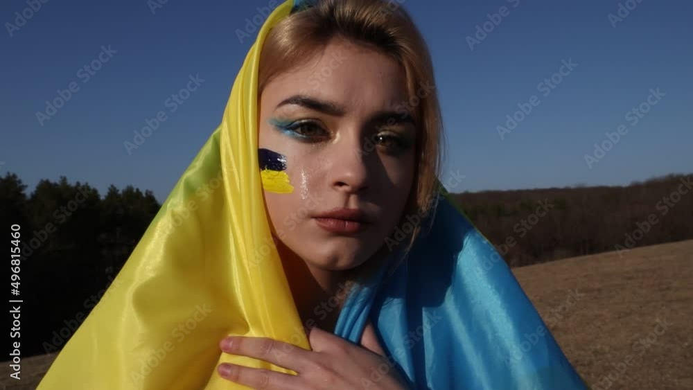 Woman wrapped in ukrainian yellow blue flag. National symbol of Ukraine ...
