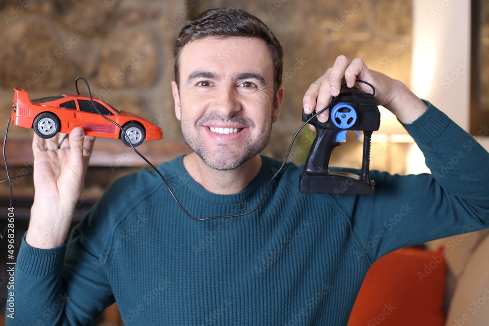 Man holding 1980s toy car with wired control Stock Photo | Adobe Stock
