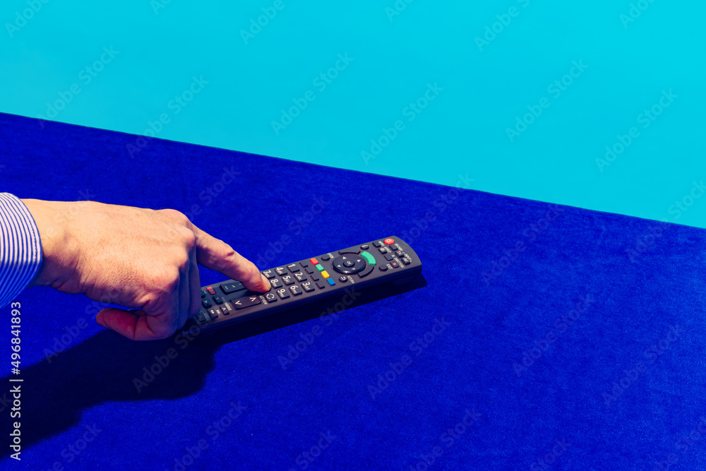 Pop art photography. Female hand press button on remote control ...