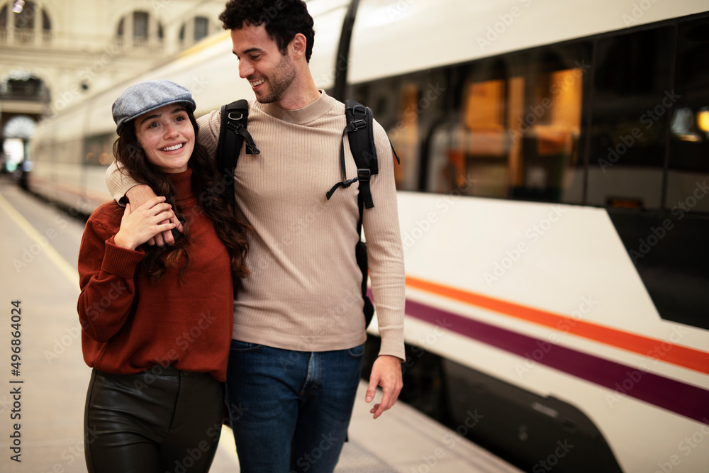 Beautiful couple at railway station waiting for the train. Young woman ...