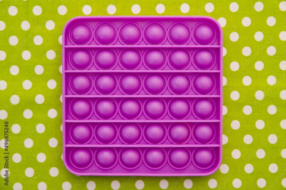 Sensory fidget toy "Pop-it". Instrument for fine motoric skils, tool to ...