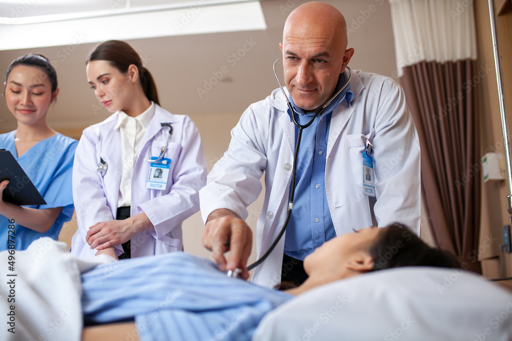 Group of doctor visiting ward have woman patient and check her with ...